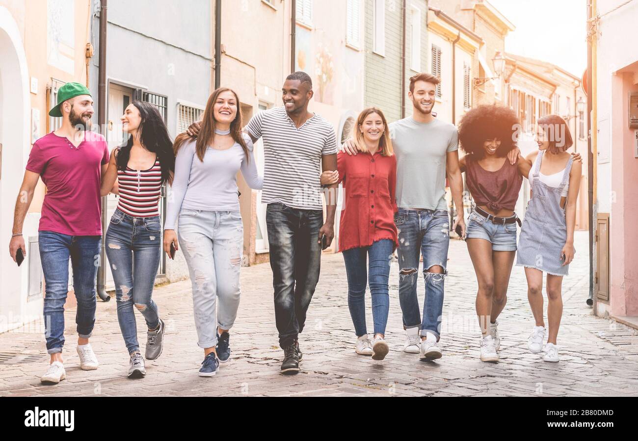 Happy milennials friends walking in old town city centre - Young people ...