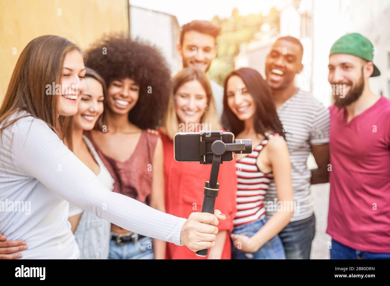 Happy millennials friends making video feed with smartphone outdoor ...