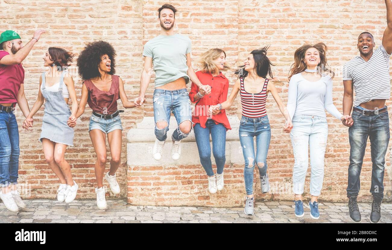 Happy millennials friends jumping outdoor - Young people having fun ...