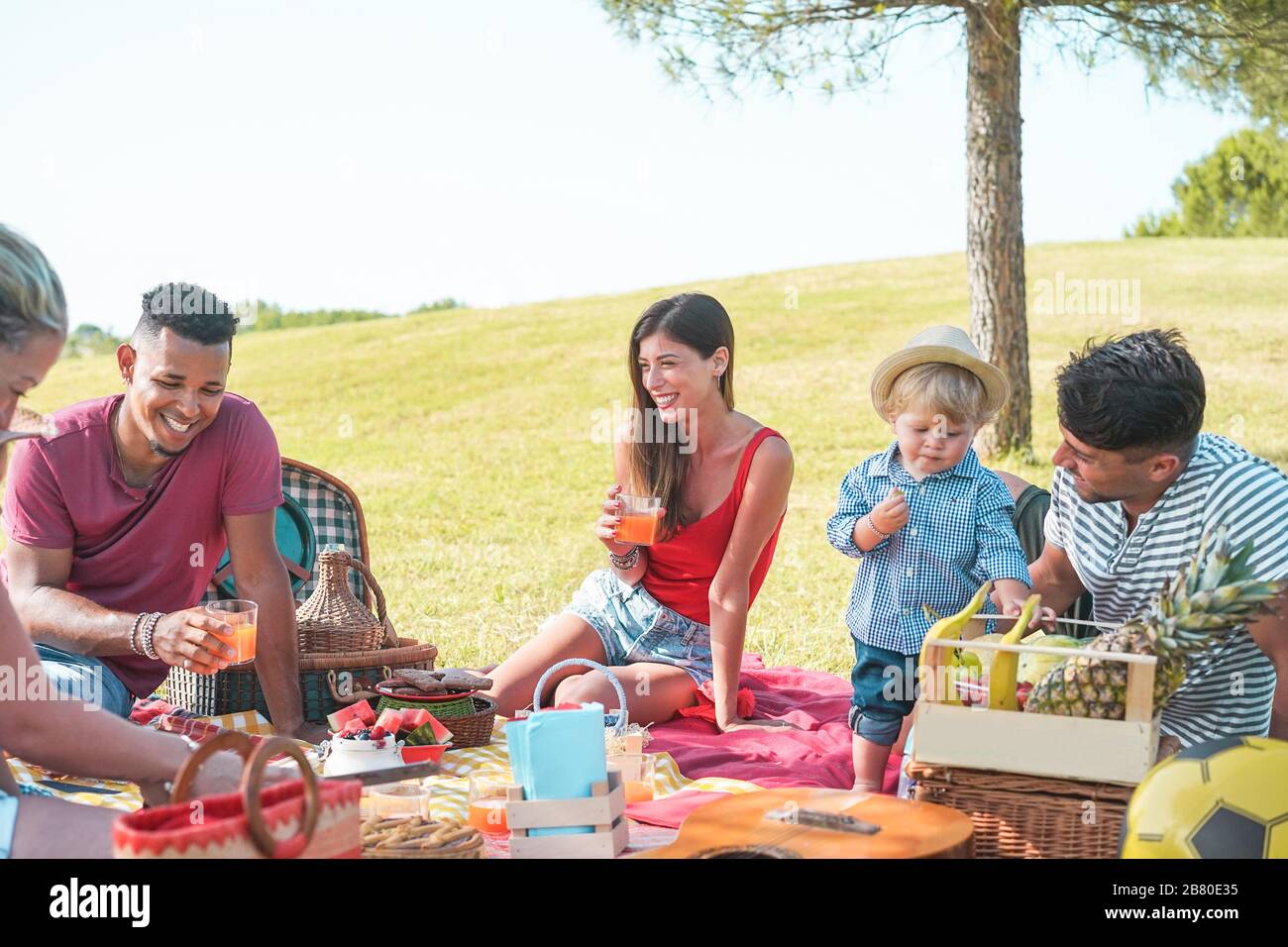 Multiracial happy families doing picnic in park outdoor - Young parents ...