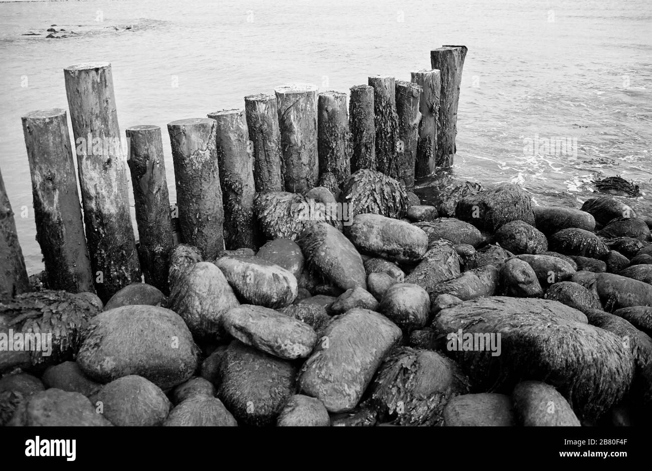 Stones rocks boulders breakwater Black and White Stock Photos & Images ...