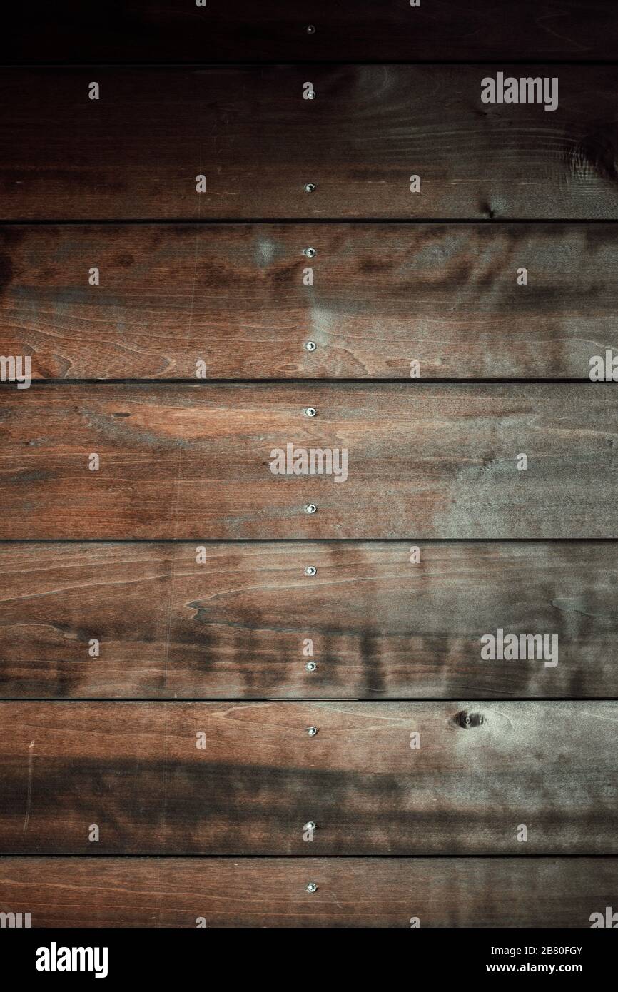Vertical closeup shot of a wooden floor with dark brown horizontal ...