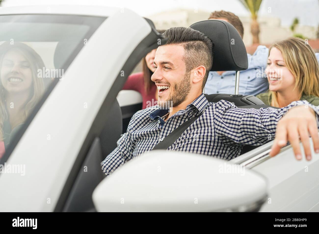 Happy friends having fun in convertible car on summer vacation - Young ...
