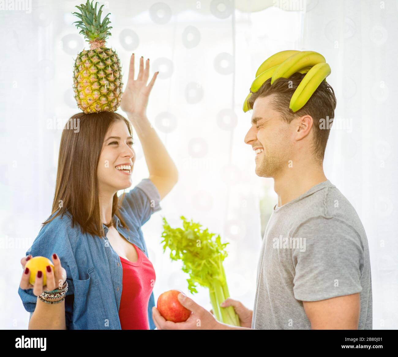 Happy couple having fun at home with healthy food - People cooking ...