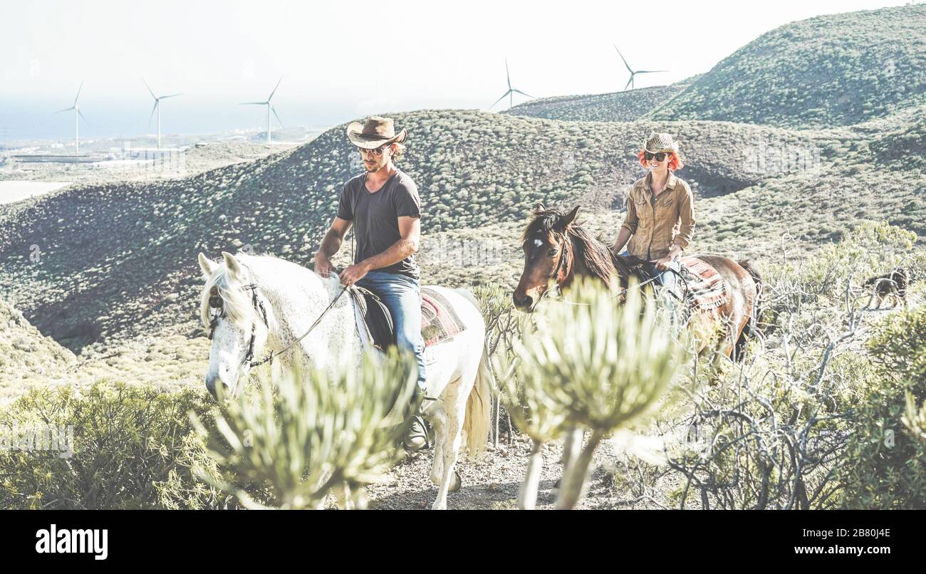 Couple riding horses in countryside nature tour - Happy people having ...