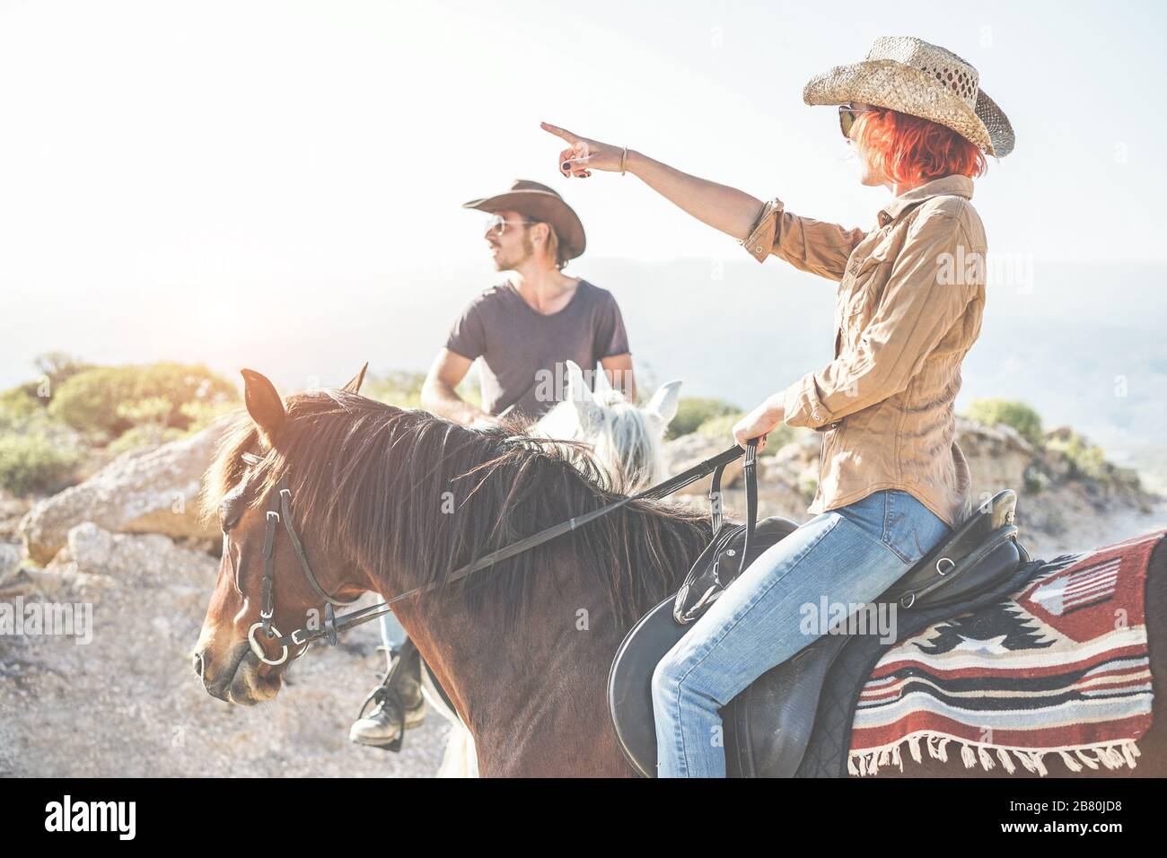 Couple riding horses in countryside on excursion nature tour - Happy ...