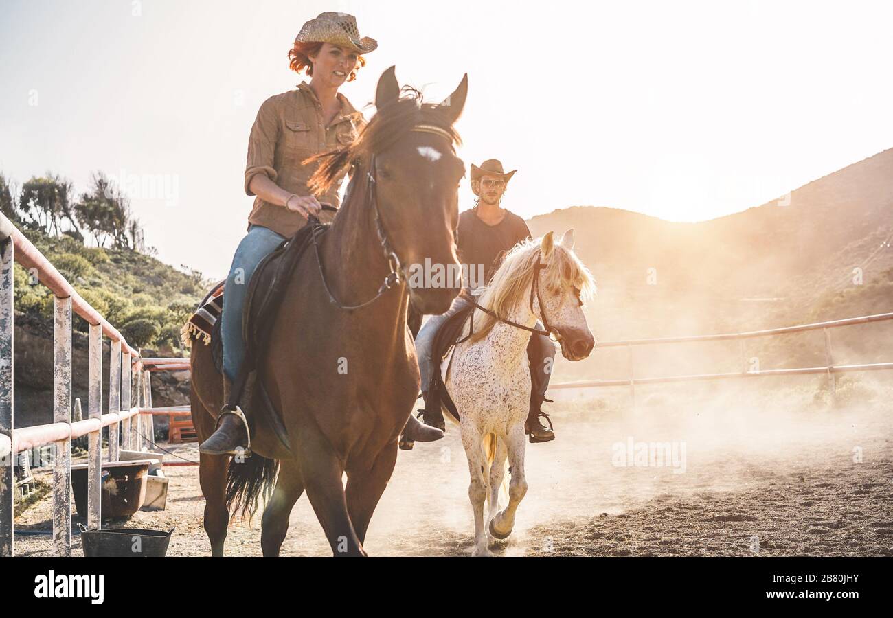 Real people riding horses inside corral - Wild couple having fun in ...