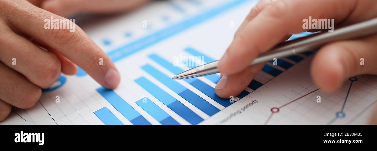 Group of people deliberate on problem with infographics Stock Photo - Alamy