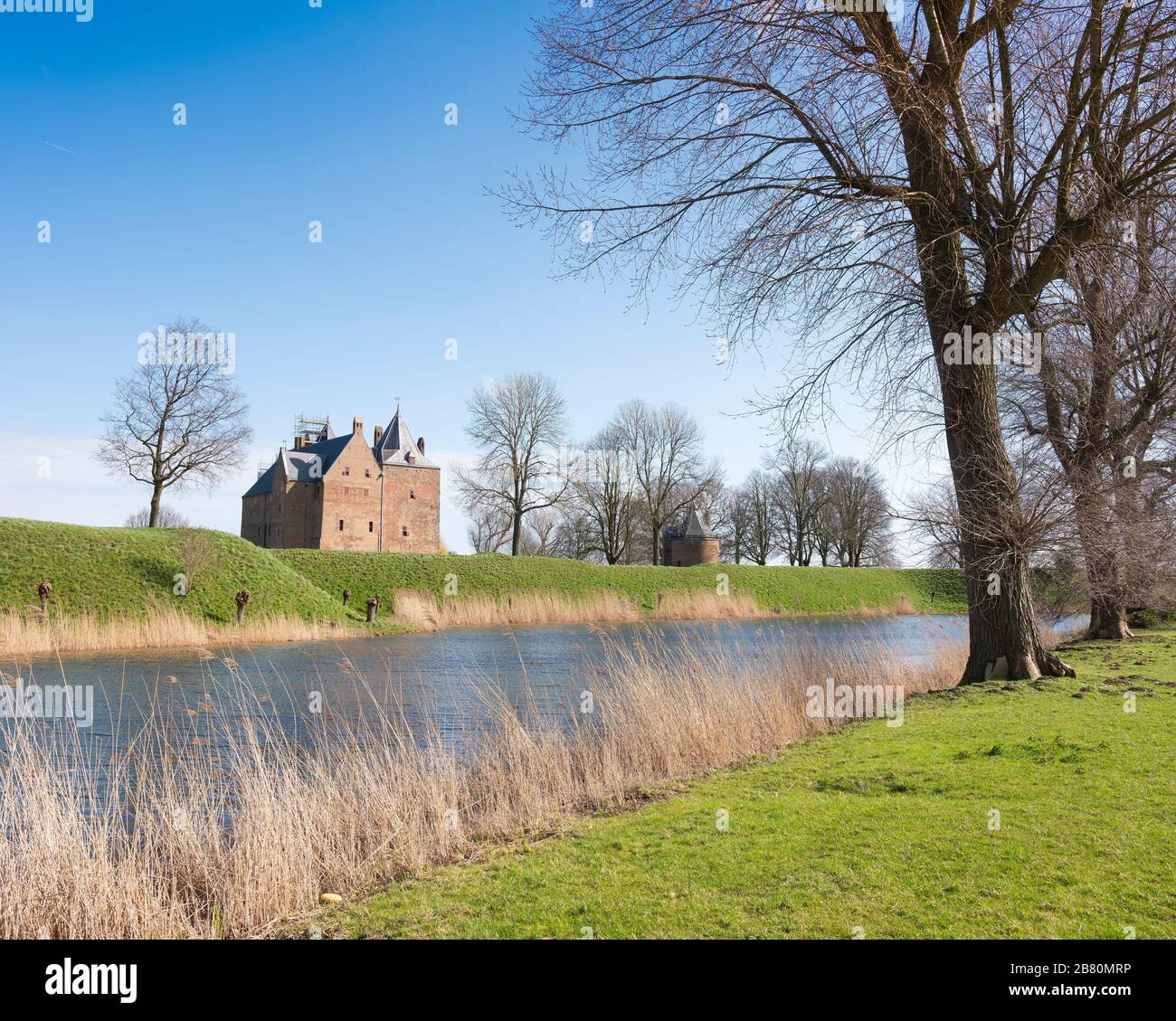 castle loevestein and moat under blue sky in the netherlands near river ...