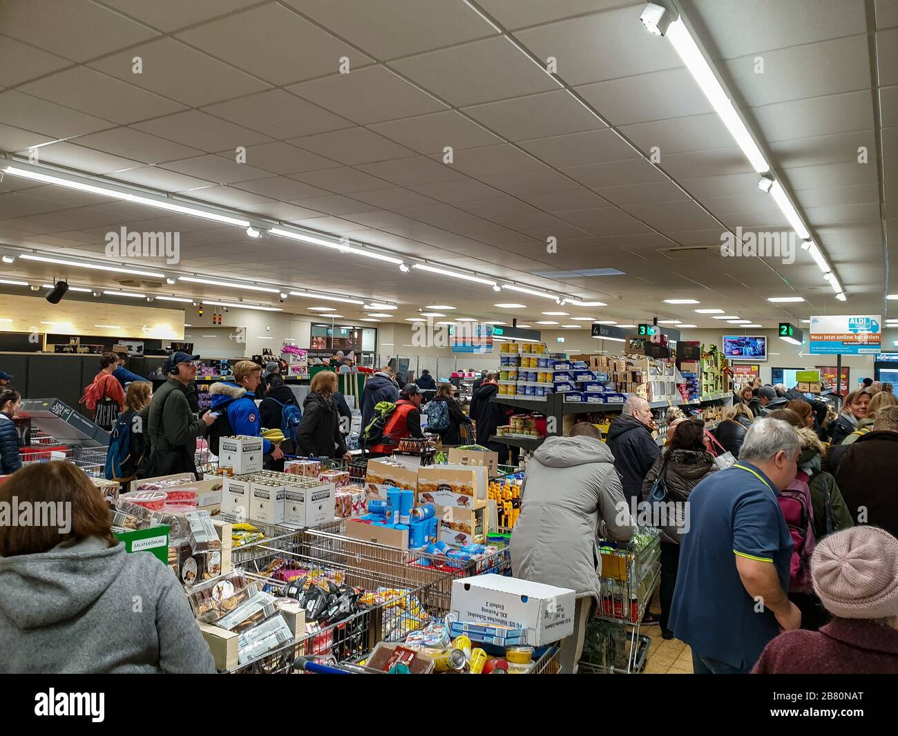 Munich, Germany, 14 of april 2020: huge queue in front of the checkout ...
