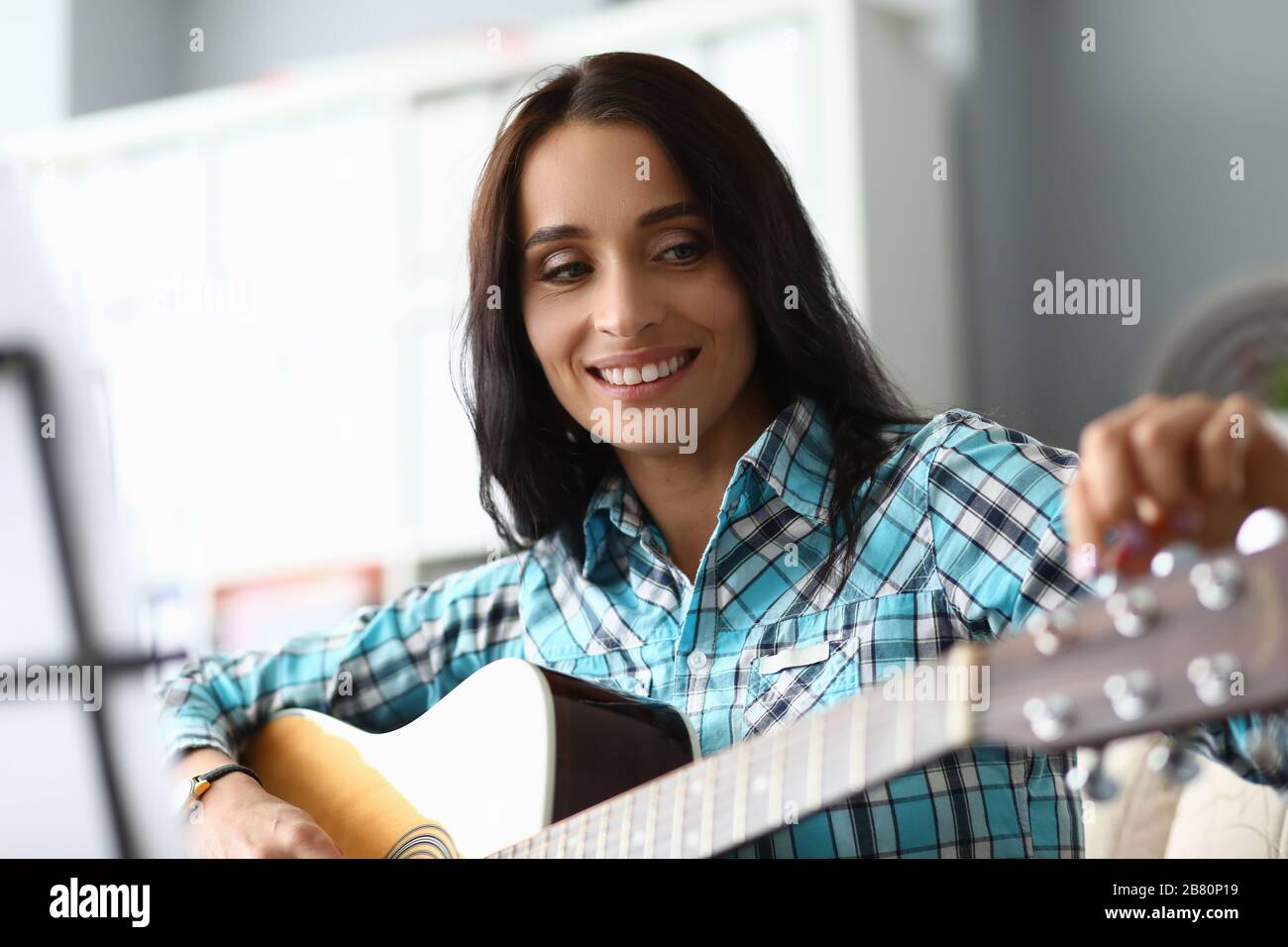 Woman smile and set up instrument before playing Stock Photo - Alamy
