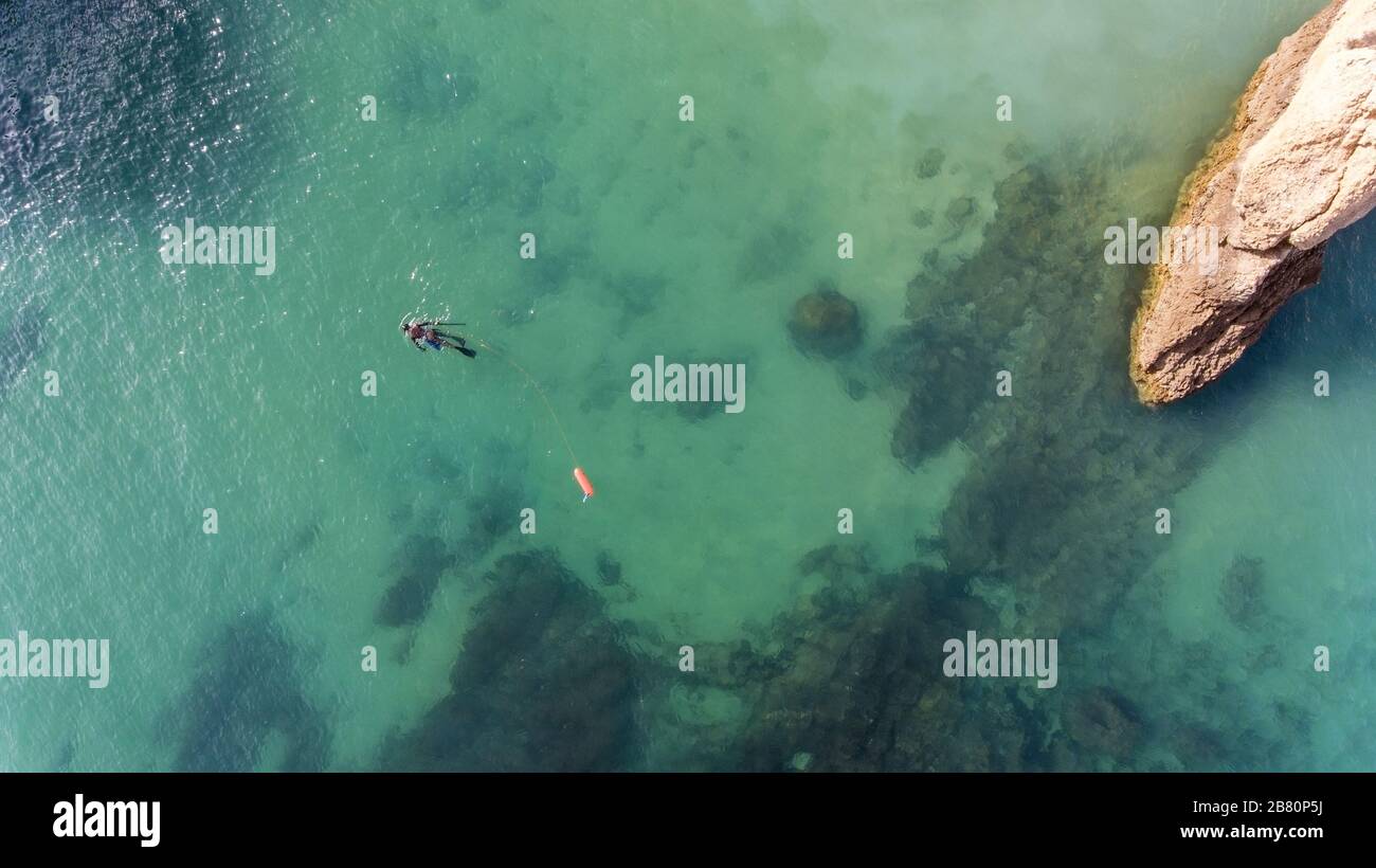 Underwater hunter on the surface of the water while hunting on the ...