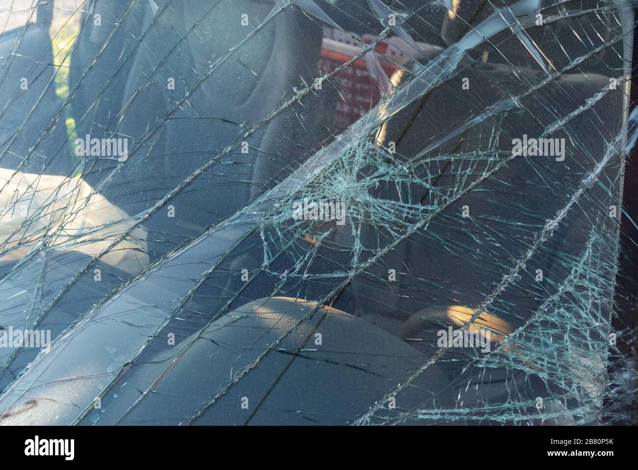 Broken windshield in a car after a crash, and driving while alcohol ...