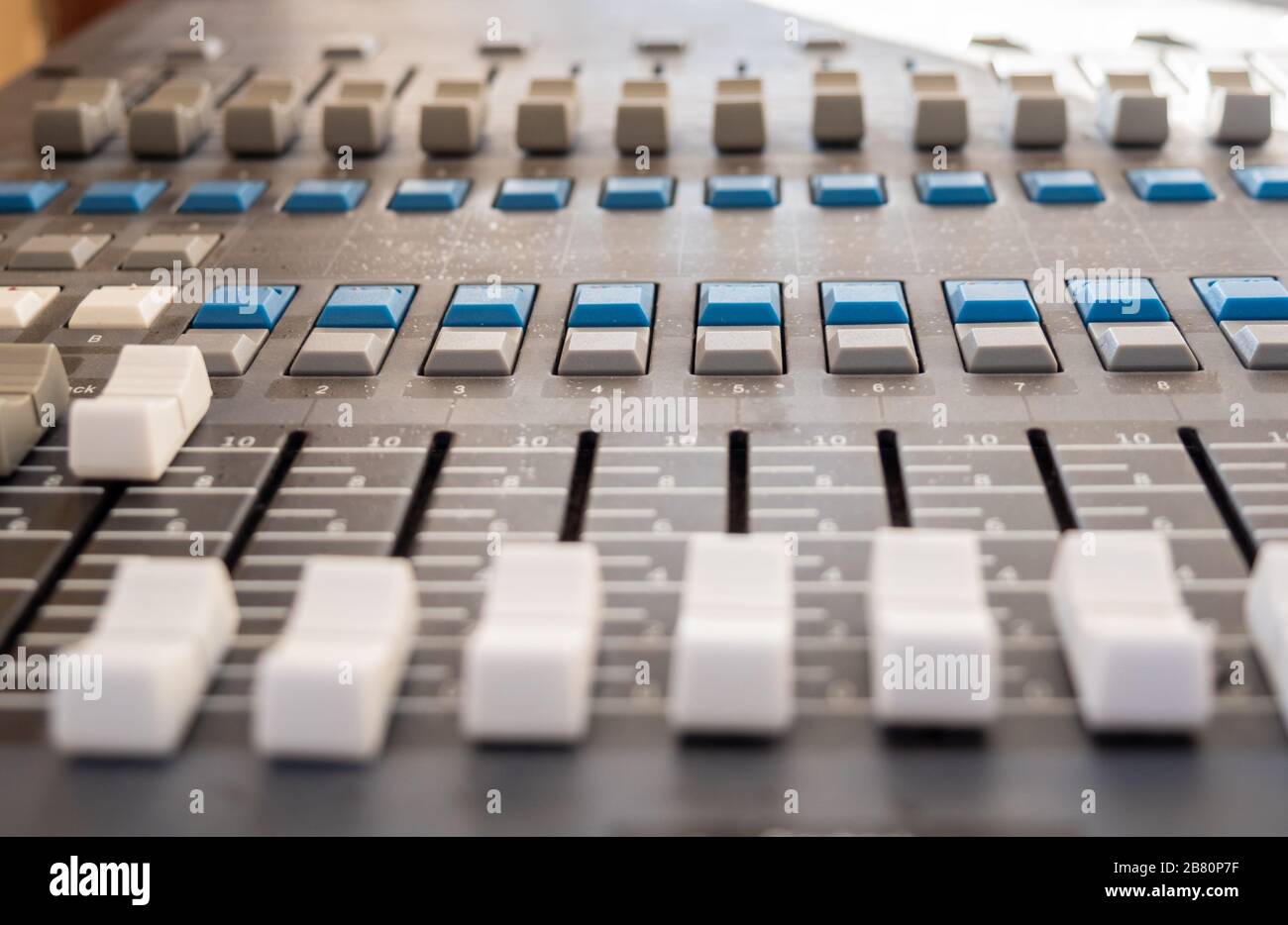 Sound mixer control panel with sliders and buttons closeup view ...