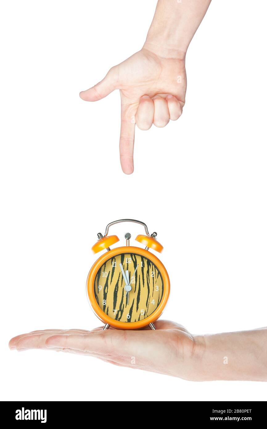 Specifying the correct time by hand. On a white background Stock Photo ...