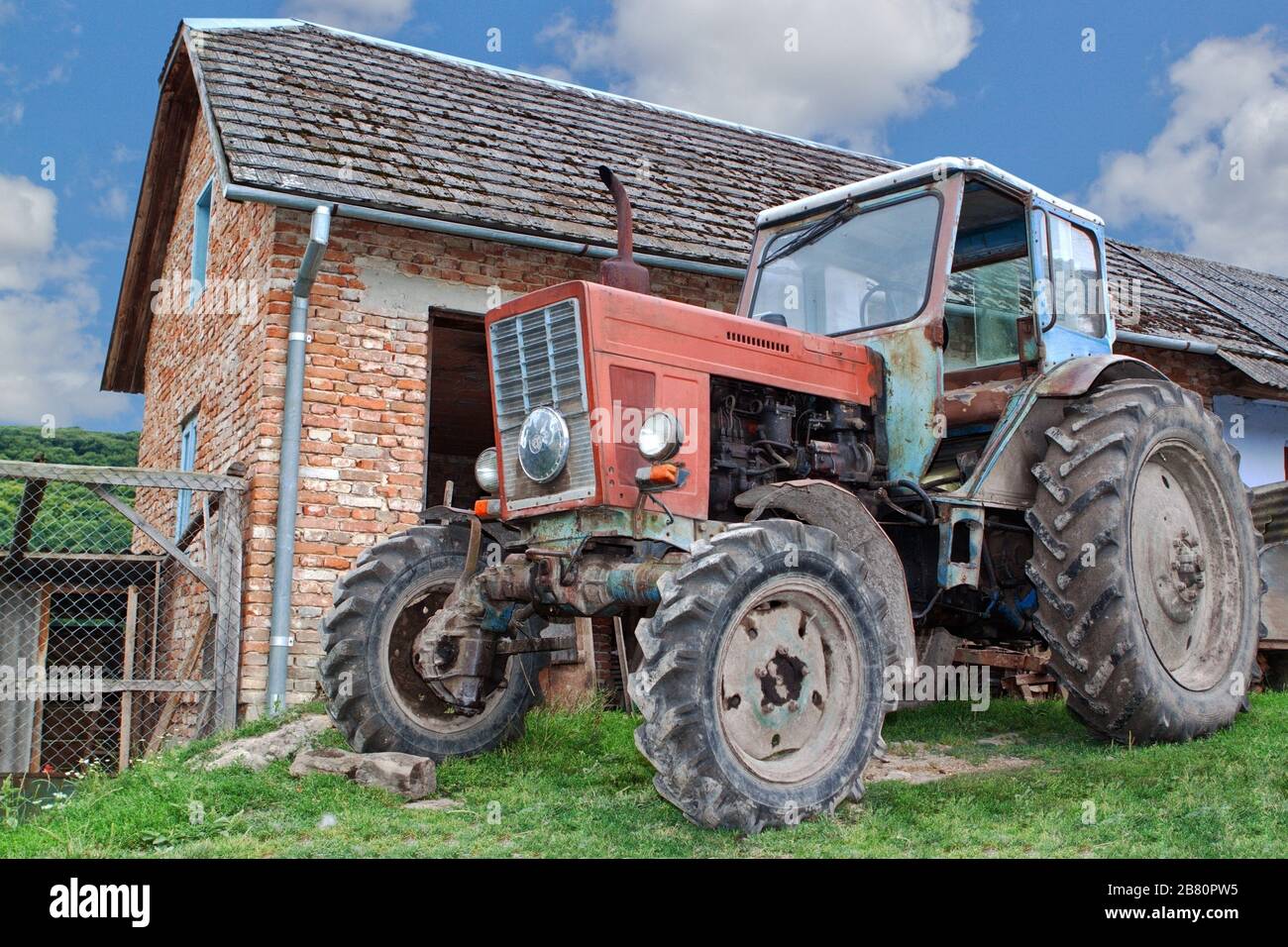 Antique tractor on a farm in the village Stock Photo - Alamy
