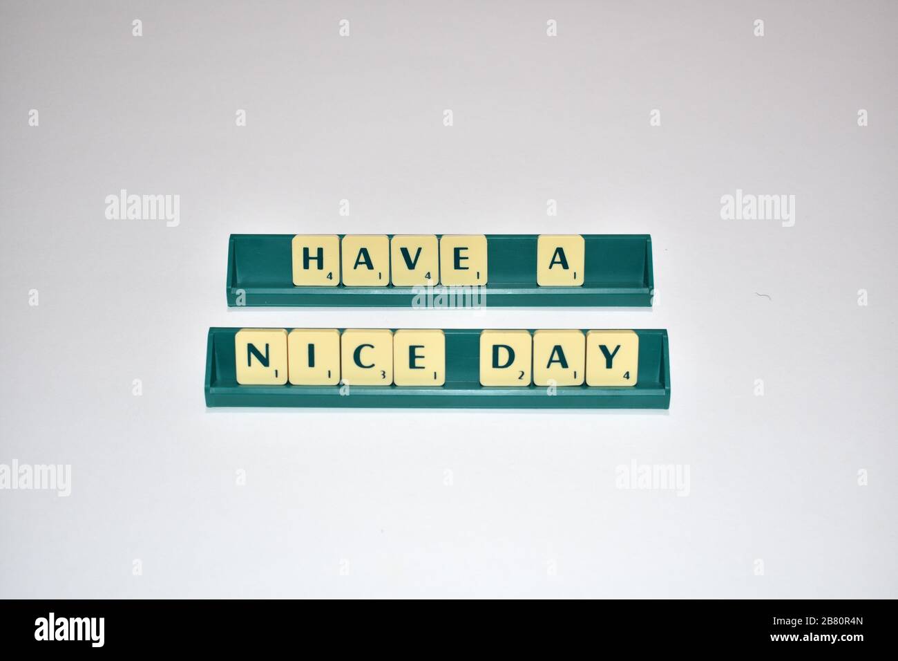 Scrabble tiles spell out Have a Nice day. Motivational quote Scrabble ...
