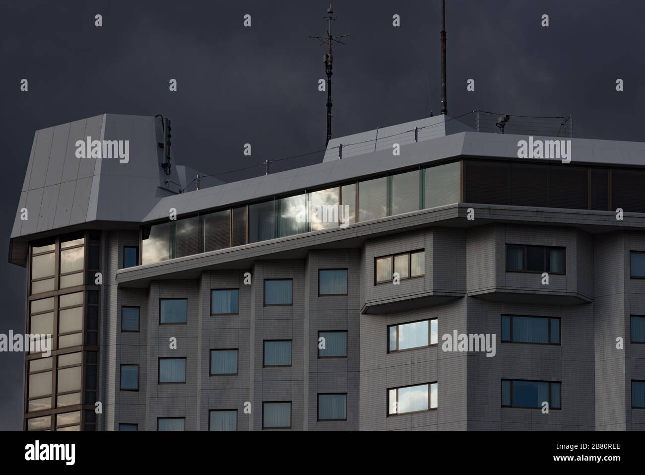 Clouds reflected in windows of building Stock Photo - Alamy