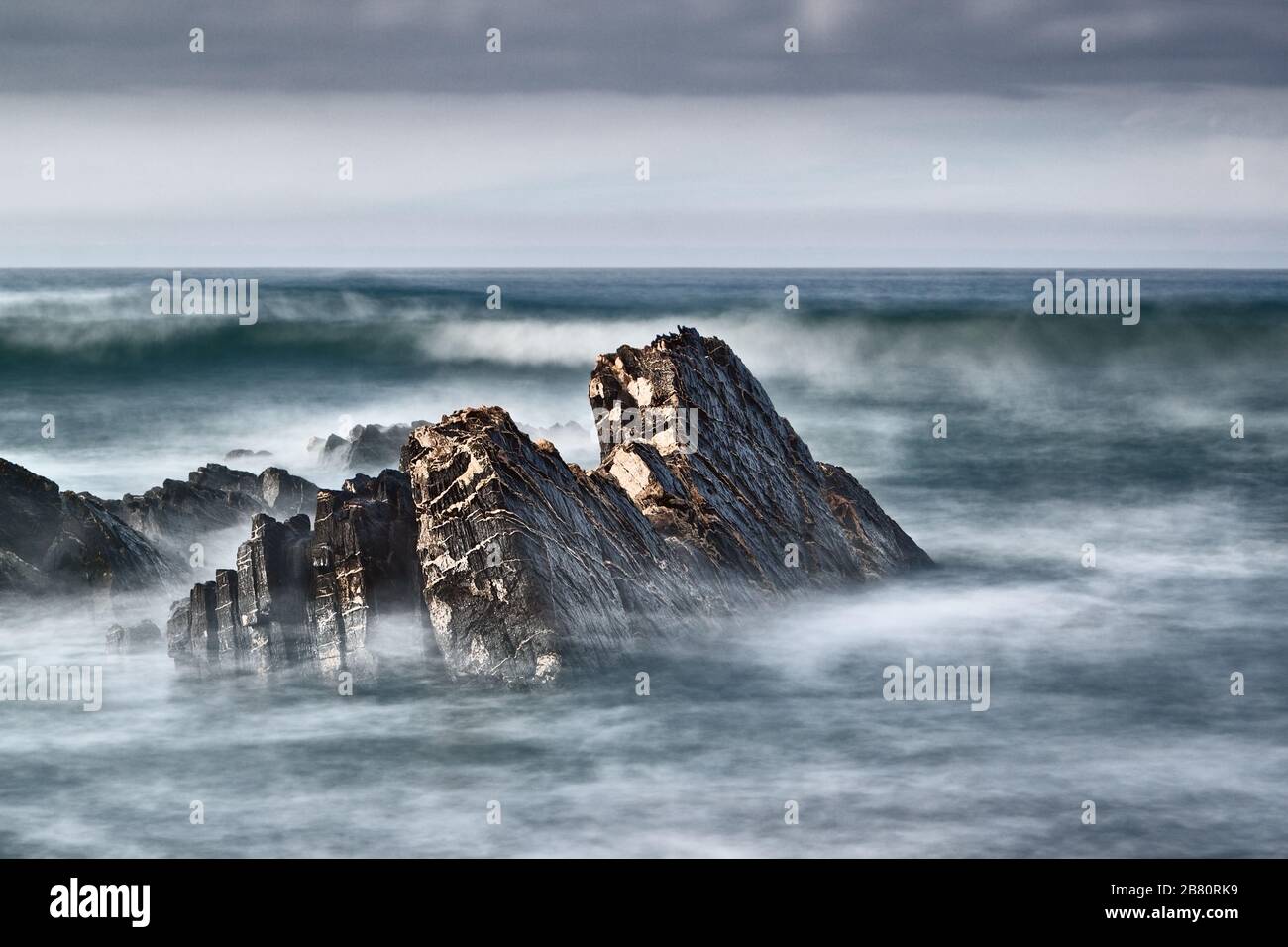 Beautiful seascape. Sea and rock at the sunset Stock Photo - Alamy