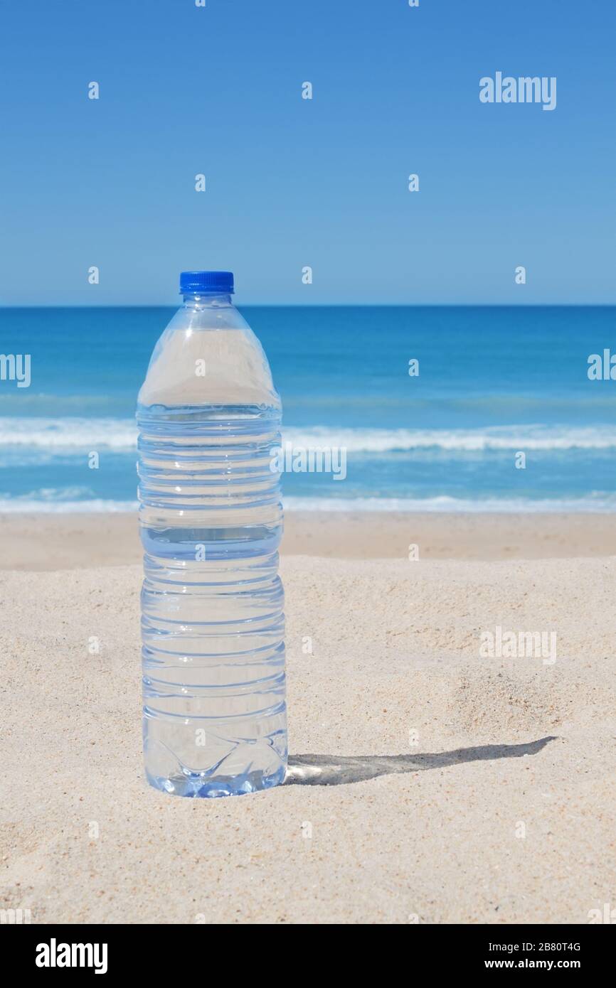 A bottle of cool water on the beach near the sea Stock Photo - Alamy