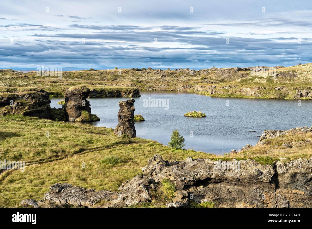 tranquil landscape with solitary lava monoliths at Lake Myvatn in ...