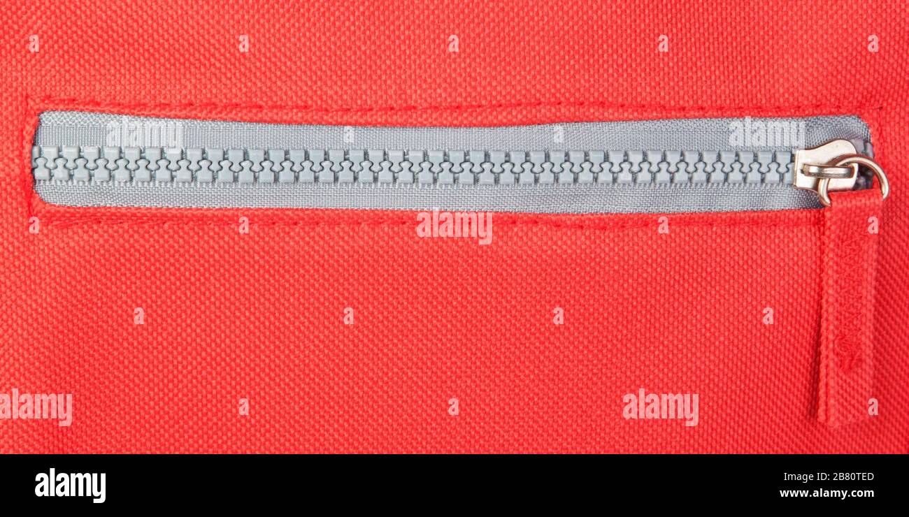Zipper on a red background. Fastener Stock Photo - Alamy