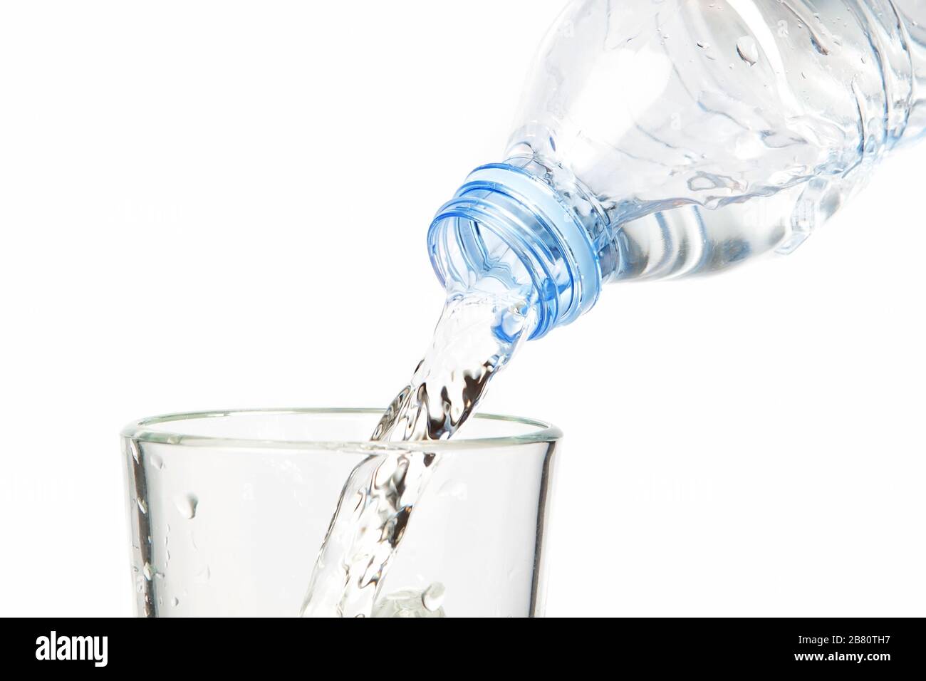 Clean water flowing into the bottle. On a white background Stock Photo ...