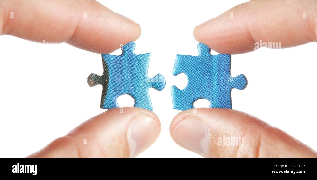 Connecting two puzzles. On a white background Stock Photo - Alamy