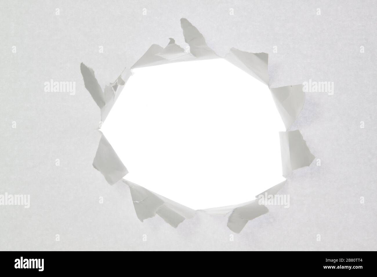 Broken a hole in a sheet of paper Stock Photo - Alamy