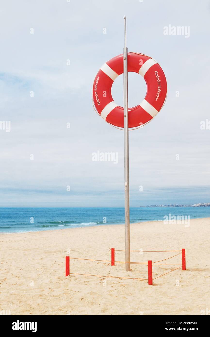 Lifebuoy on a beach of the ocean Stock Photo - Alamy
