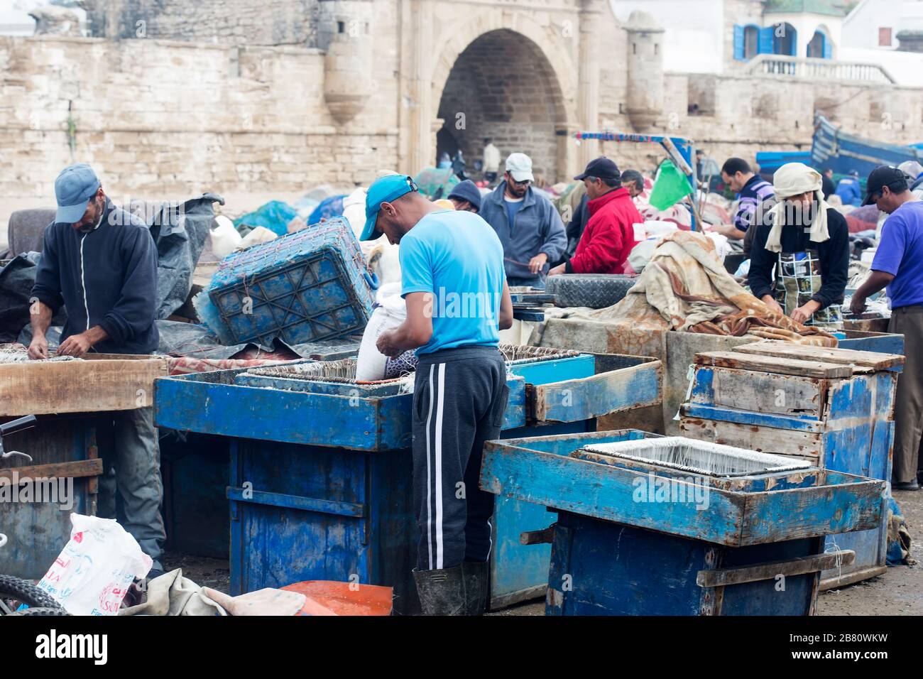 Fishermen working on fishing nests in the port Stock Photo - Alamy