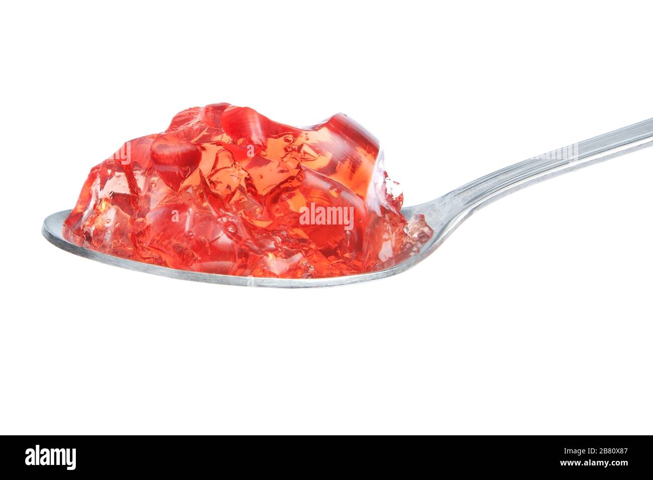A spoon full of red gelatin. On a white background Stock Photo - Alamy