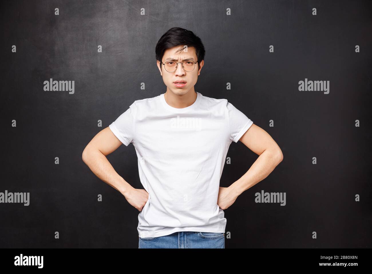 Explain yourself now. Serious-looking angry and displeased asian elder ...