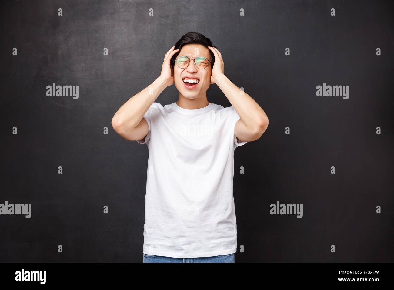 Depressed and tensed young asian guy fed up with studying, have lots on ...