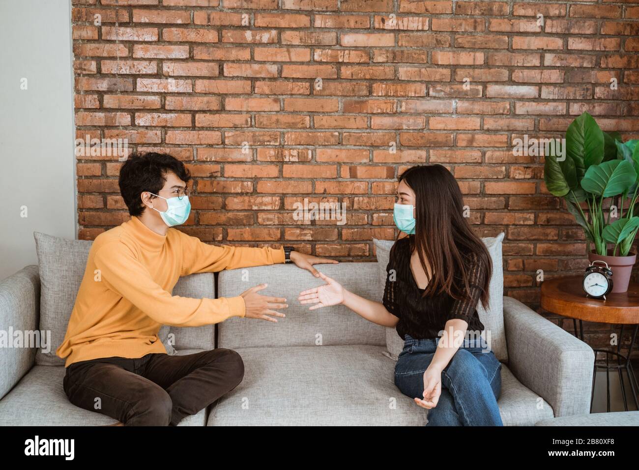 scare to touch on social distancing. two people sitting far away from ...