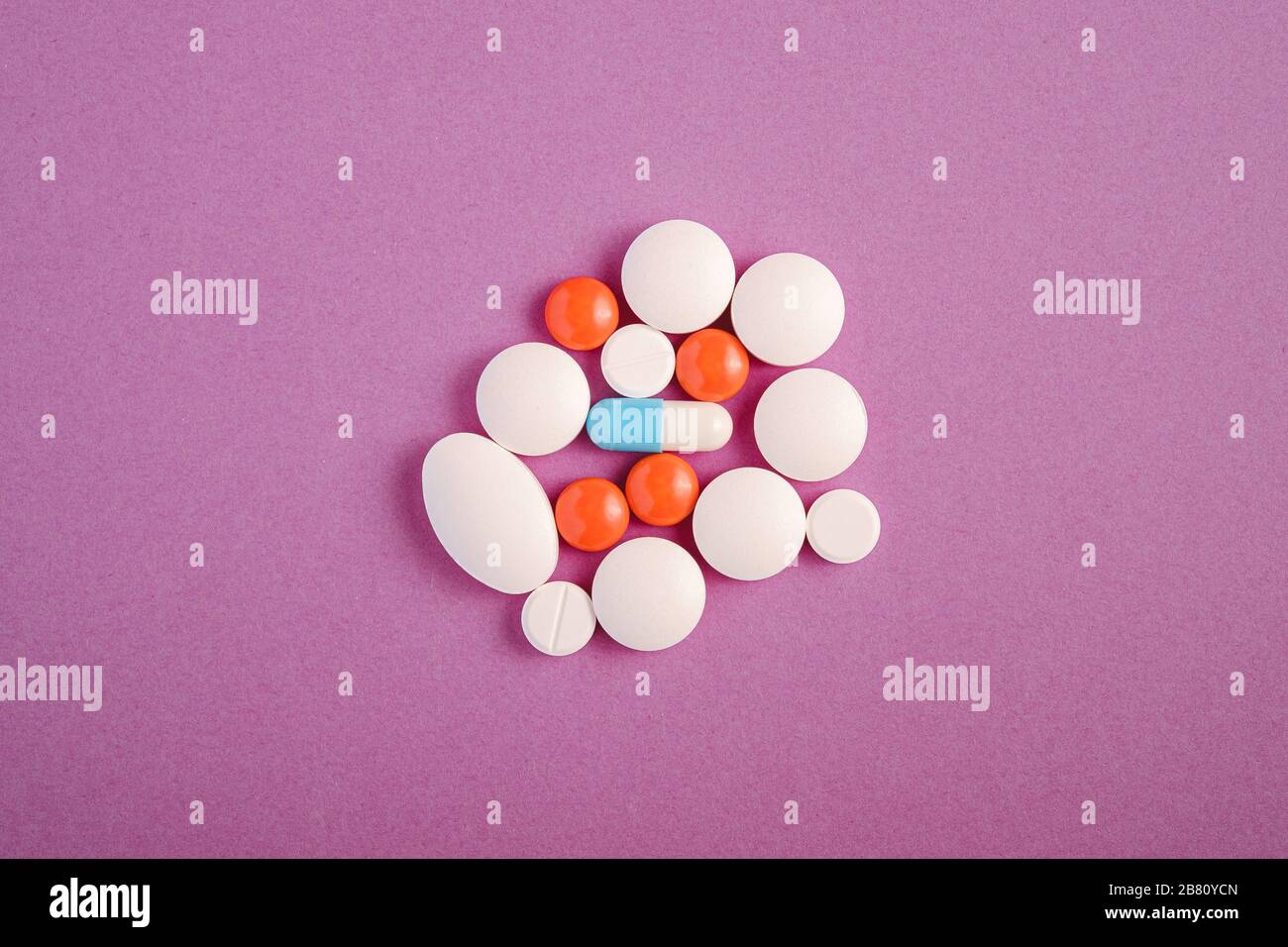 Pills and tablets on bright violet purple background, healthcare ...
