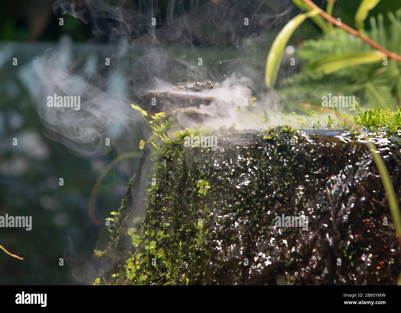 Part of the rock on which water flows and steam rises from above Stock ...