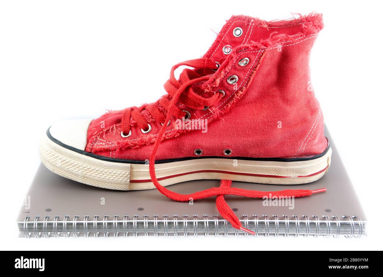 Red shoes on a school notebook. On a white background Stock Photo - Alamy