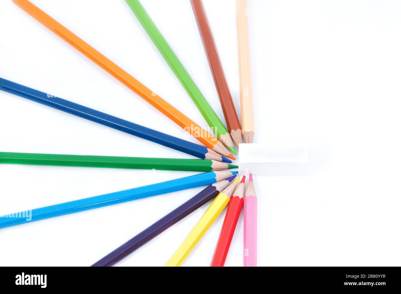 A set of colored pencils in the shape of half a star. On a white ...