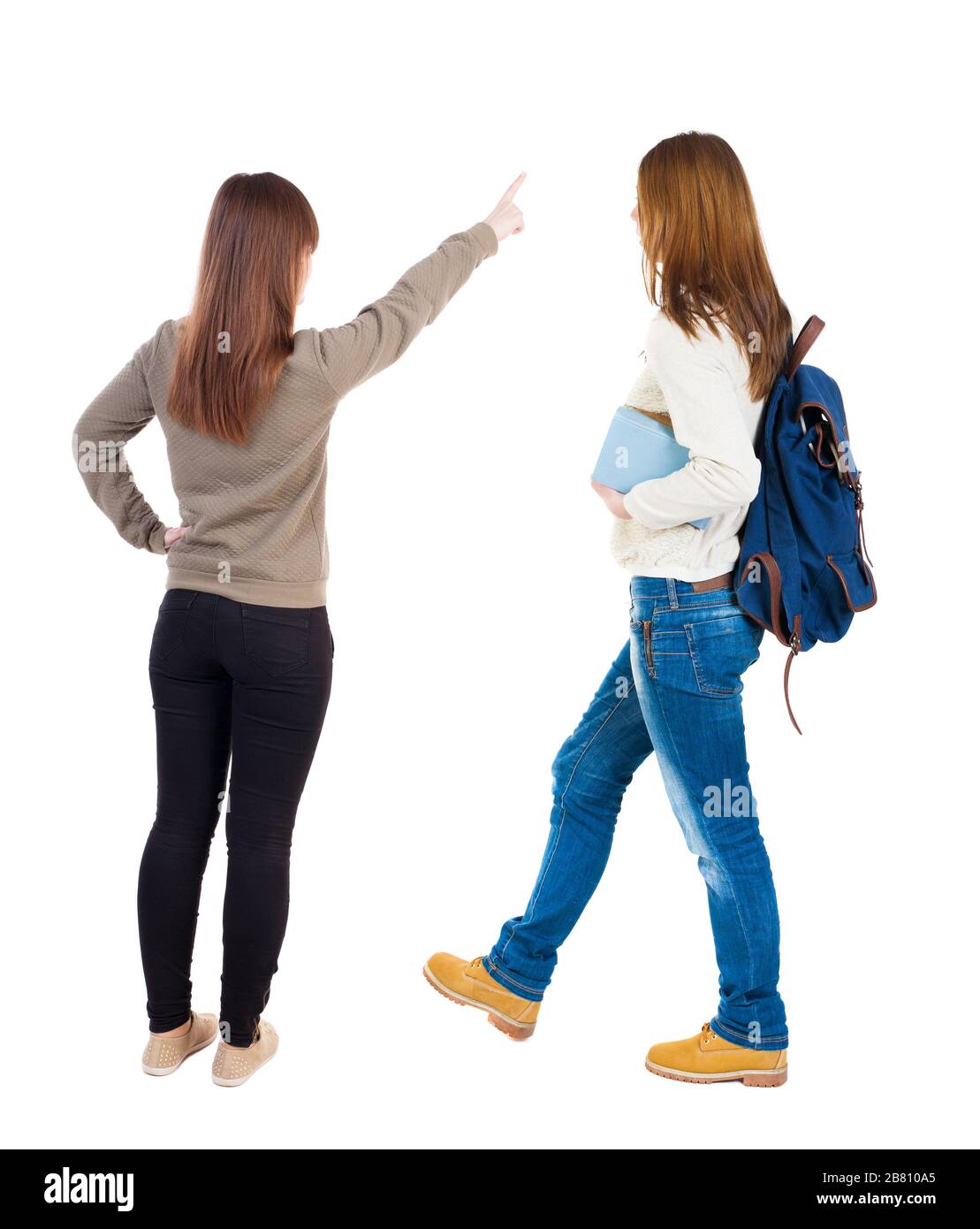 Back view of two pointing girl in sweater. Rear view people collection ...