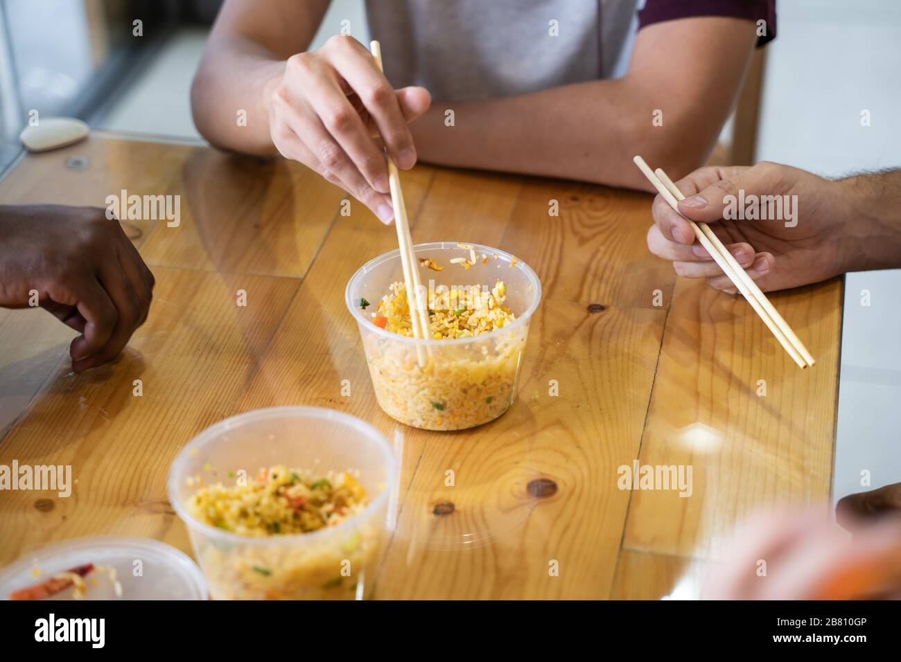 Detail of the hands of a group of young people of different ethnicities ...