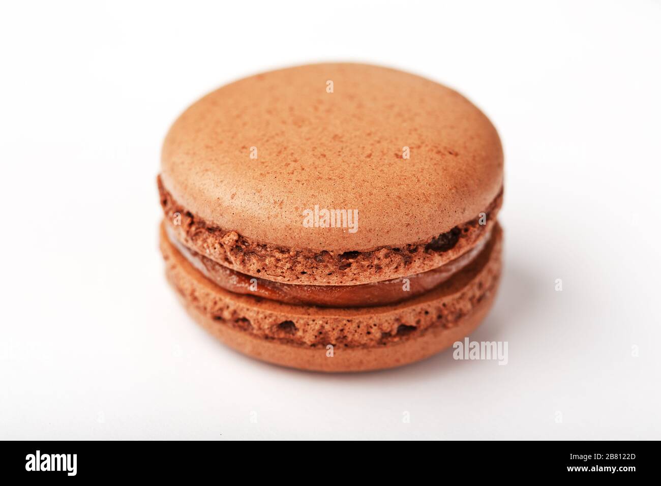 Chocolate macaroni cookies on a white background with brown filling ...