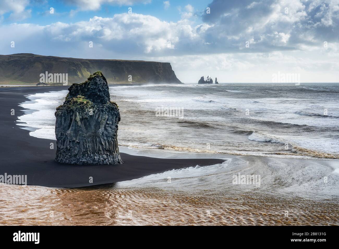 volcanic rock formation of Dyrholaey near Vik in stormy weather ...
