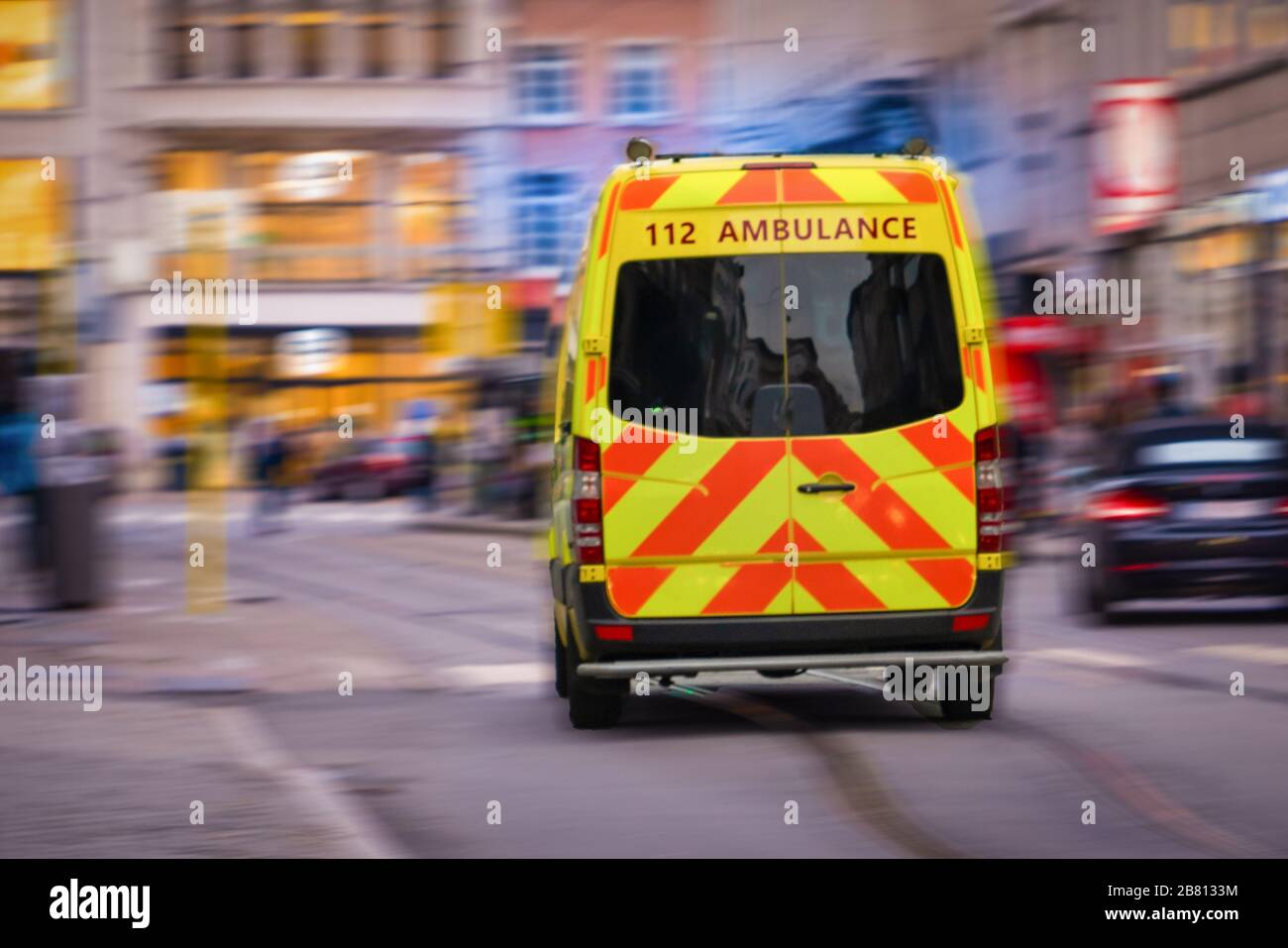 Back view of emergency ambulance car in a blurred street Stock Photo ...