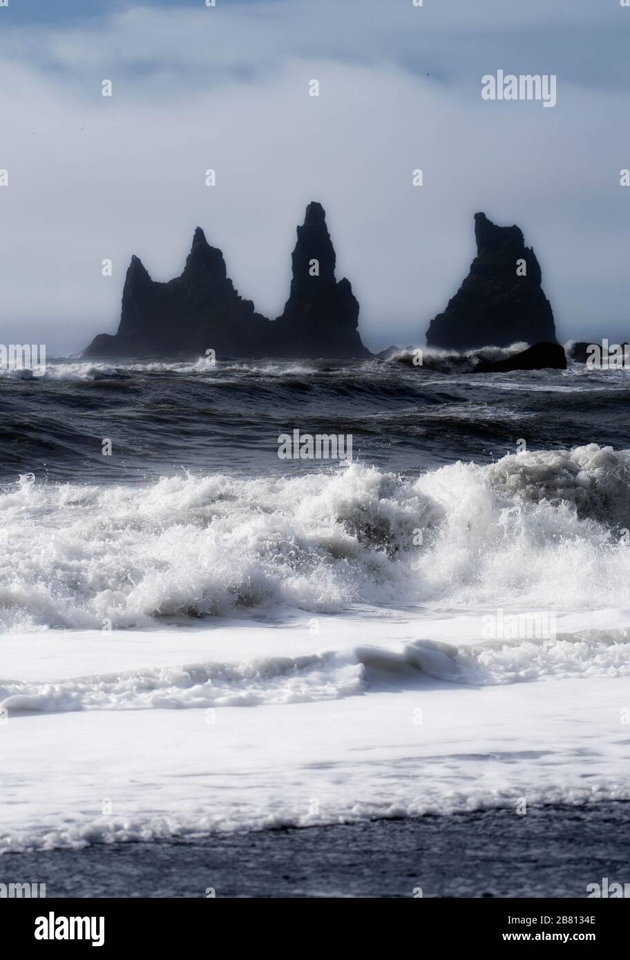 volcanic rock formation of Dyrholaey near Vik in stormy weather ...