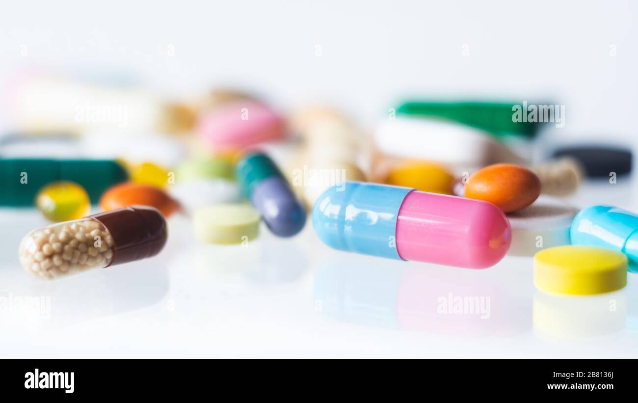 Colorful assorted pills pattern on white background Stock Photo - Alamy
