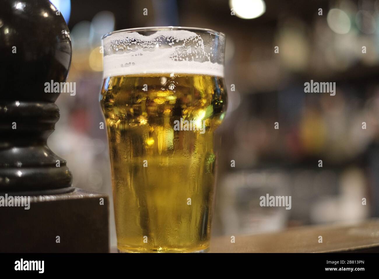 Cold beer in glass on blur background Stock Photo - Alamy