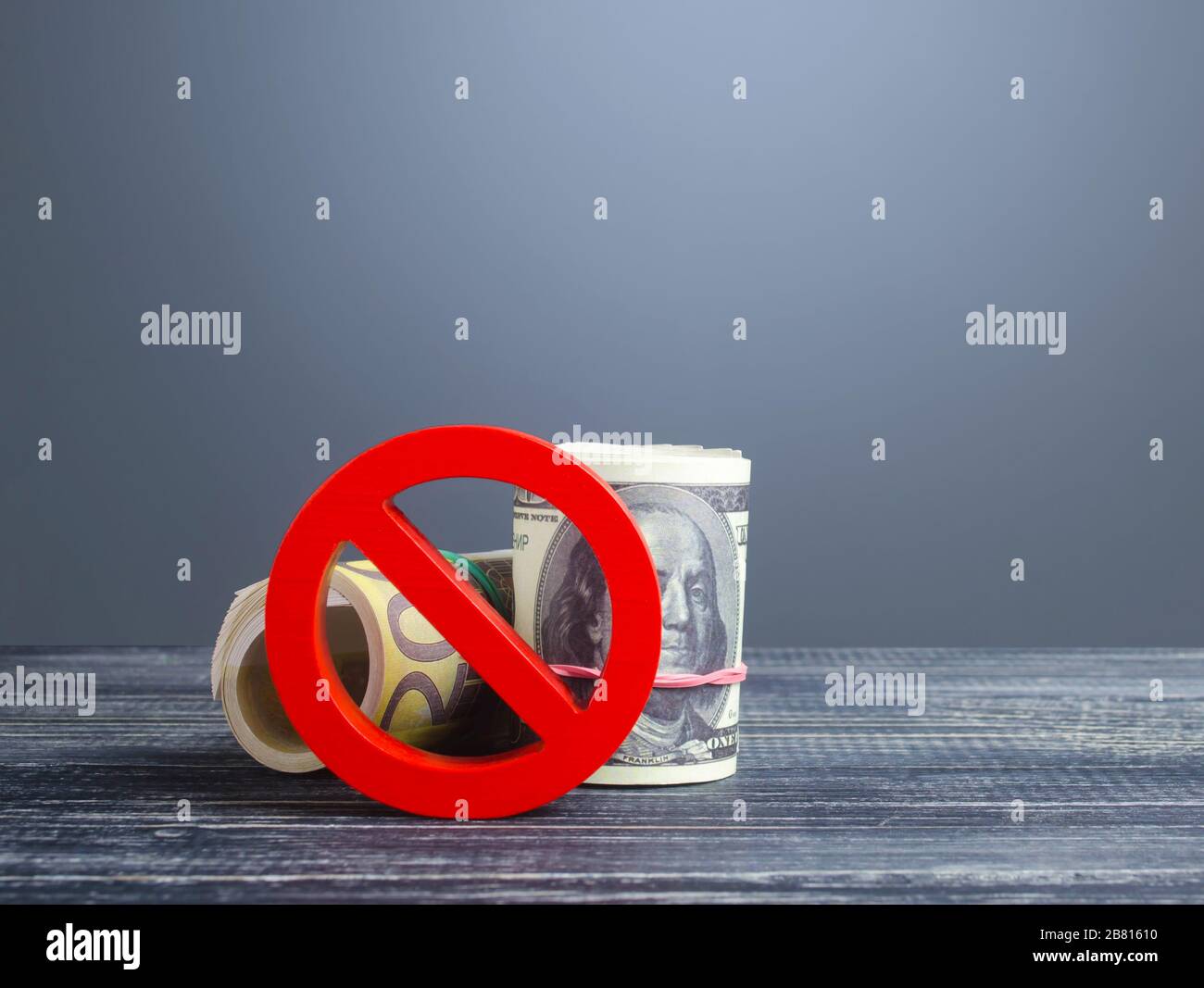 Rolls of money dollar euro blocked by red prohibition symbol NO ...