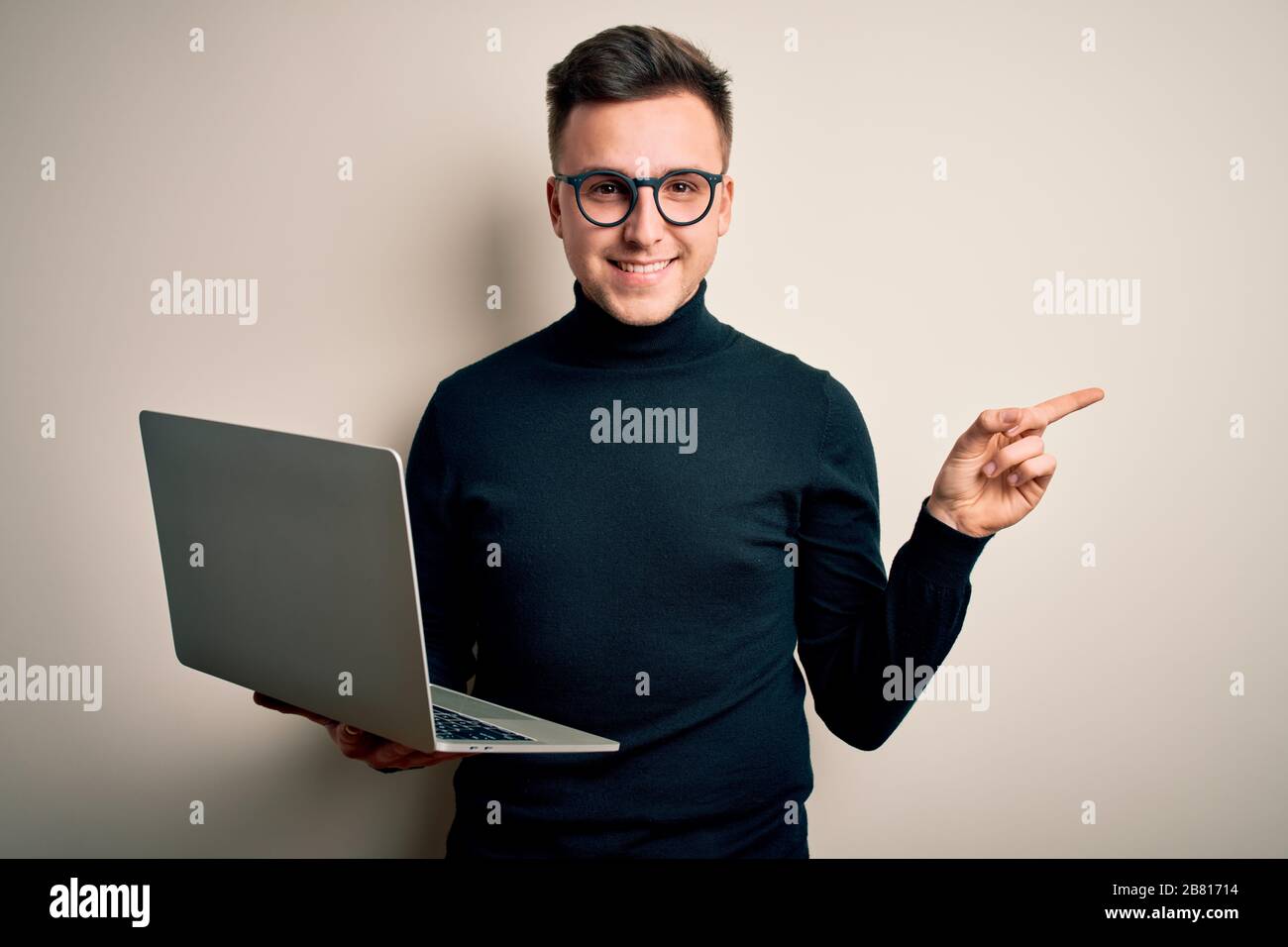 Young handsome caucasian business man wearing glasses using computer ...