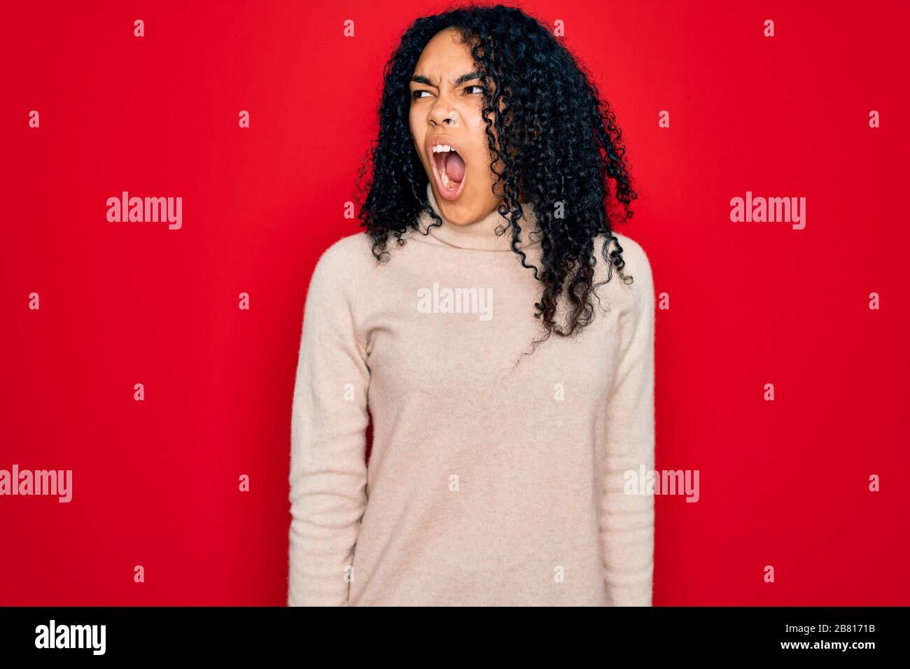 Young african american curly woman wearing casual turtleneck sweater ...